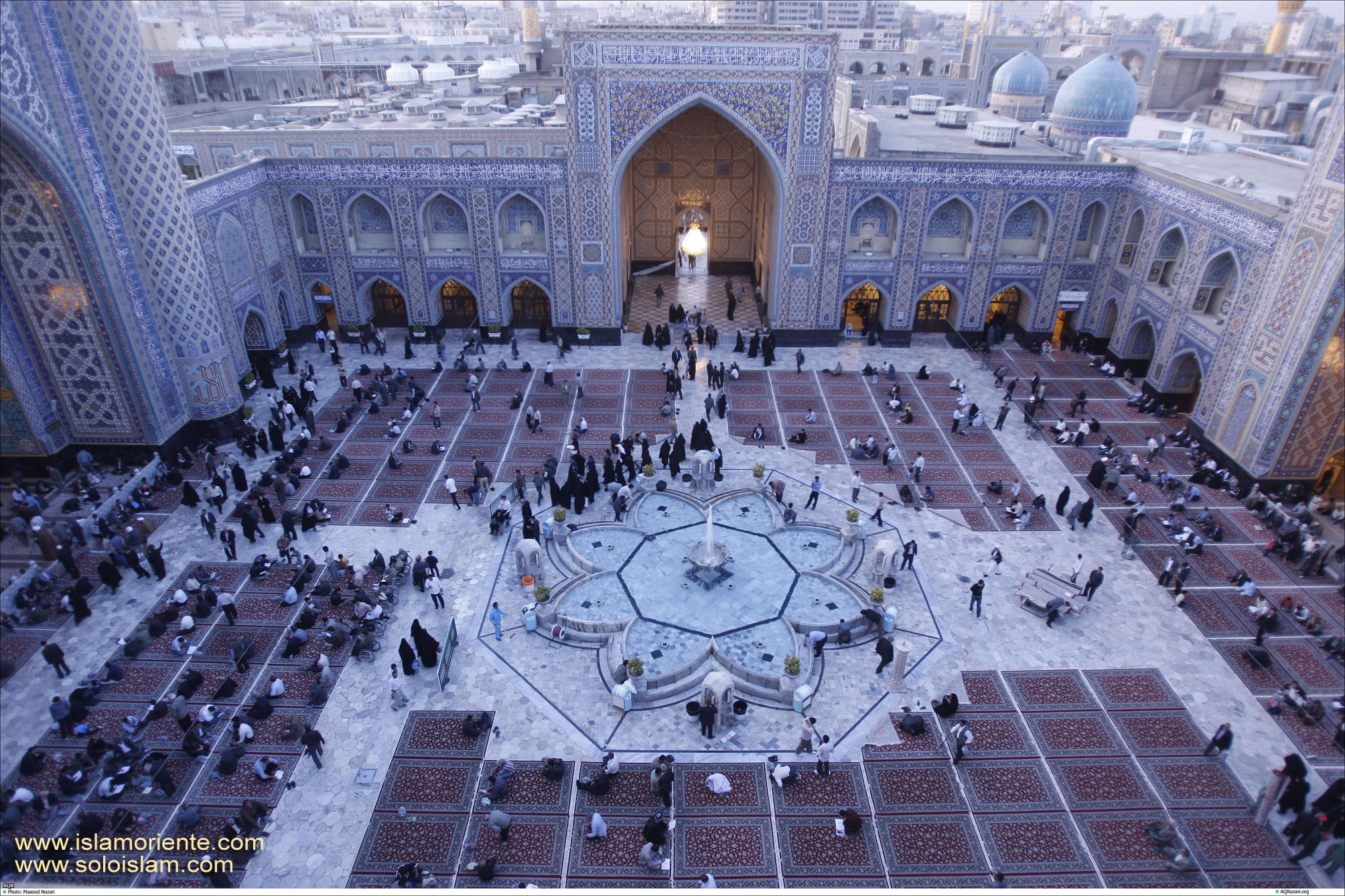 Courtyard at Imam Reza's Holy Shrine with a fountain water in the ...
